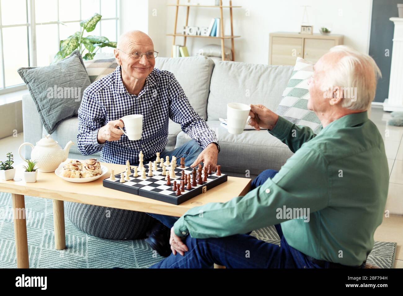 Elderly men playing chess at home Stock Photo - Alamy