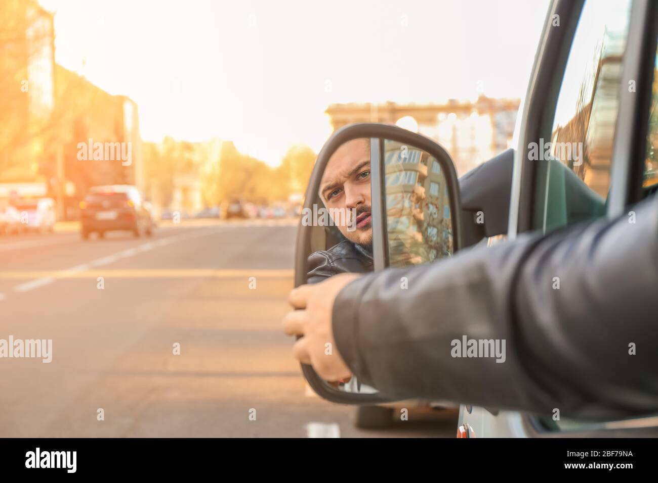 Driver adjusting side mirror of modern car Stock Photo - Alamy