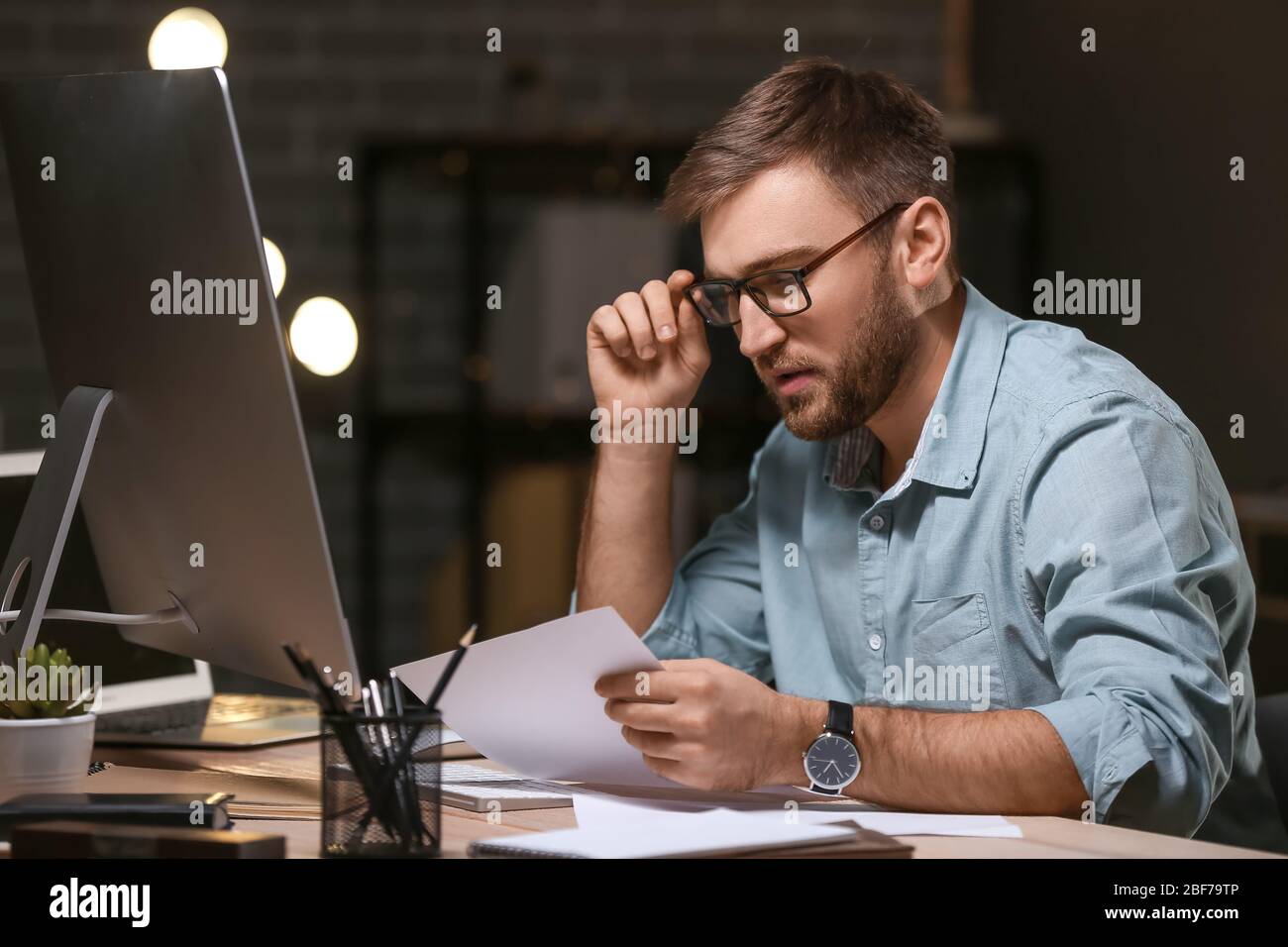 Male programmer working in office at night Stock Photo - Alamy