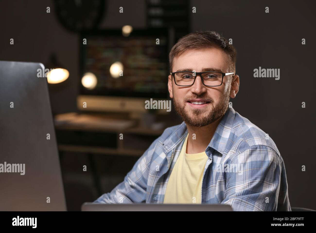 Male programmer working in office at night Stock Photo - Alamy