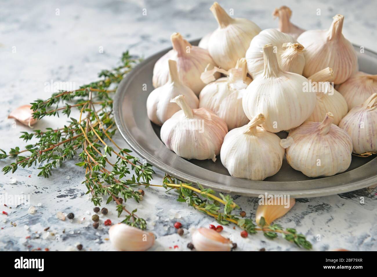 Plate with fresh garlic and herbs on white background Stock Photo - Alamy
