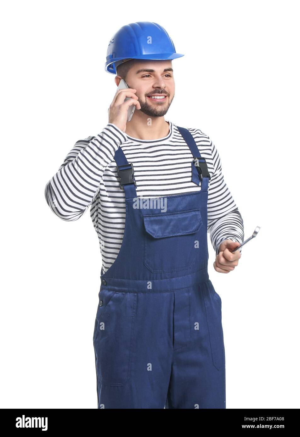 Handsome male worker talking by mobile phone on white background Stock ...