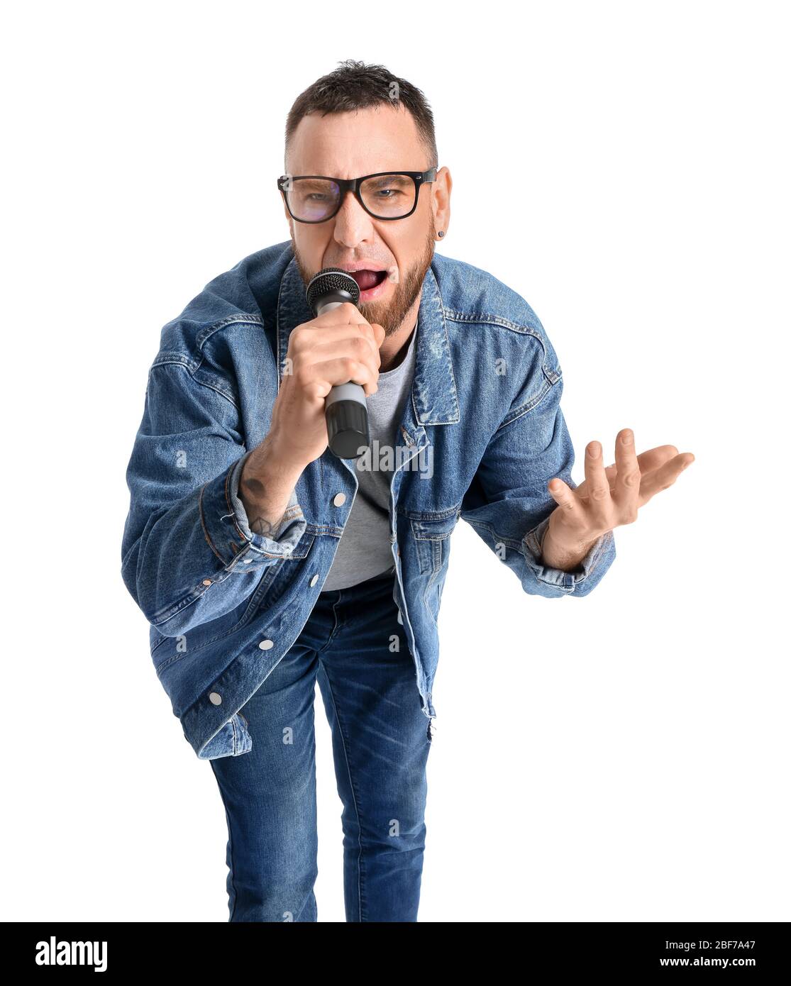 Male singer with microphone on white background Stock Photo - Alamy