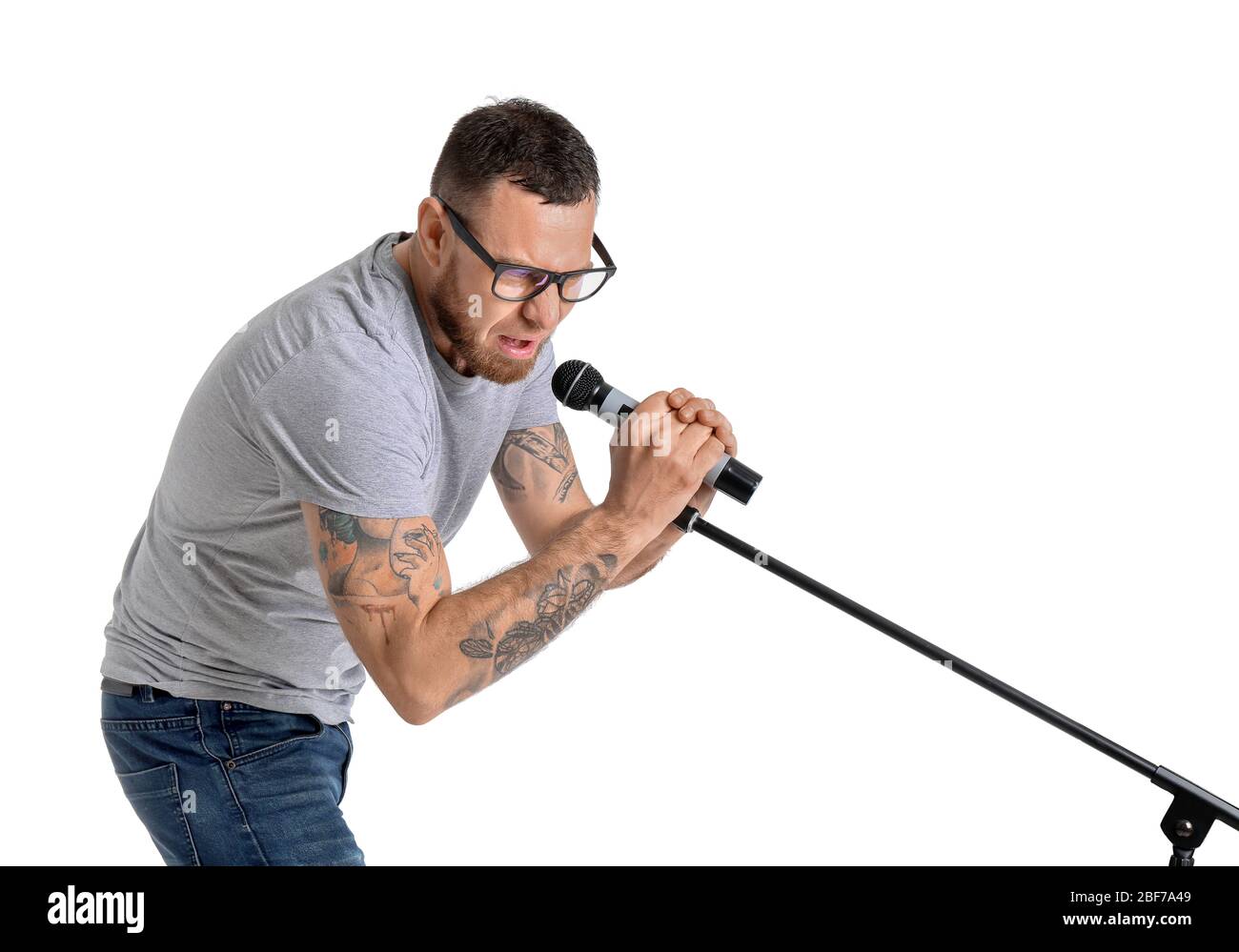 Male singer with microphone on white background Stock Photo - Alamy