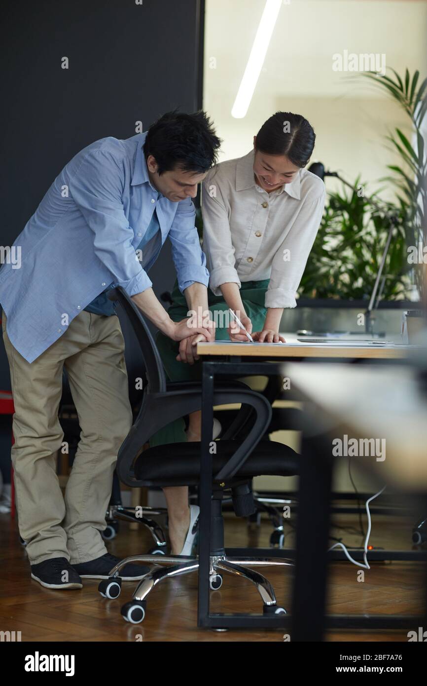 Two busy colleagues working at the table with documents at office Stock ...