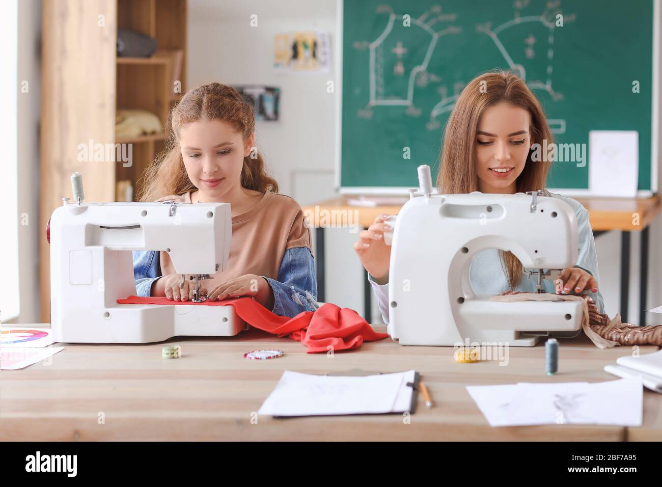 Young women during tailor's class in atelier Stock Photo - Alamy