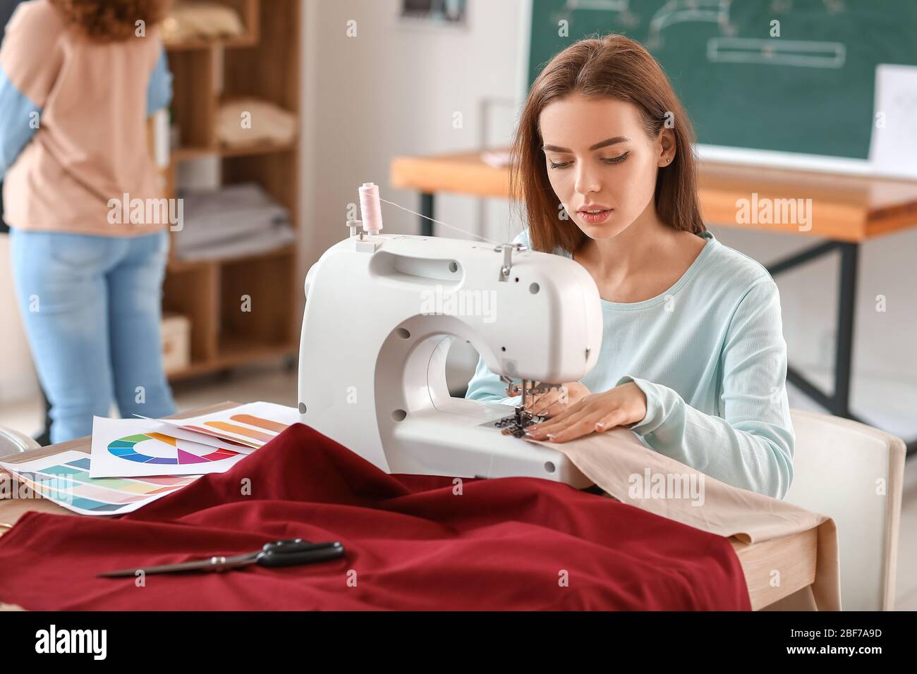 Young woman during tailor's class in atelier Stock Photo - Alamy