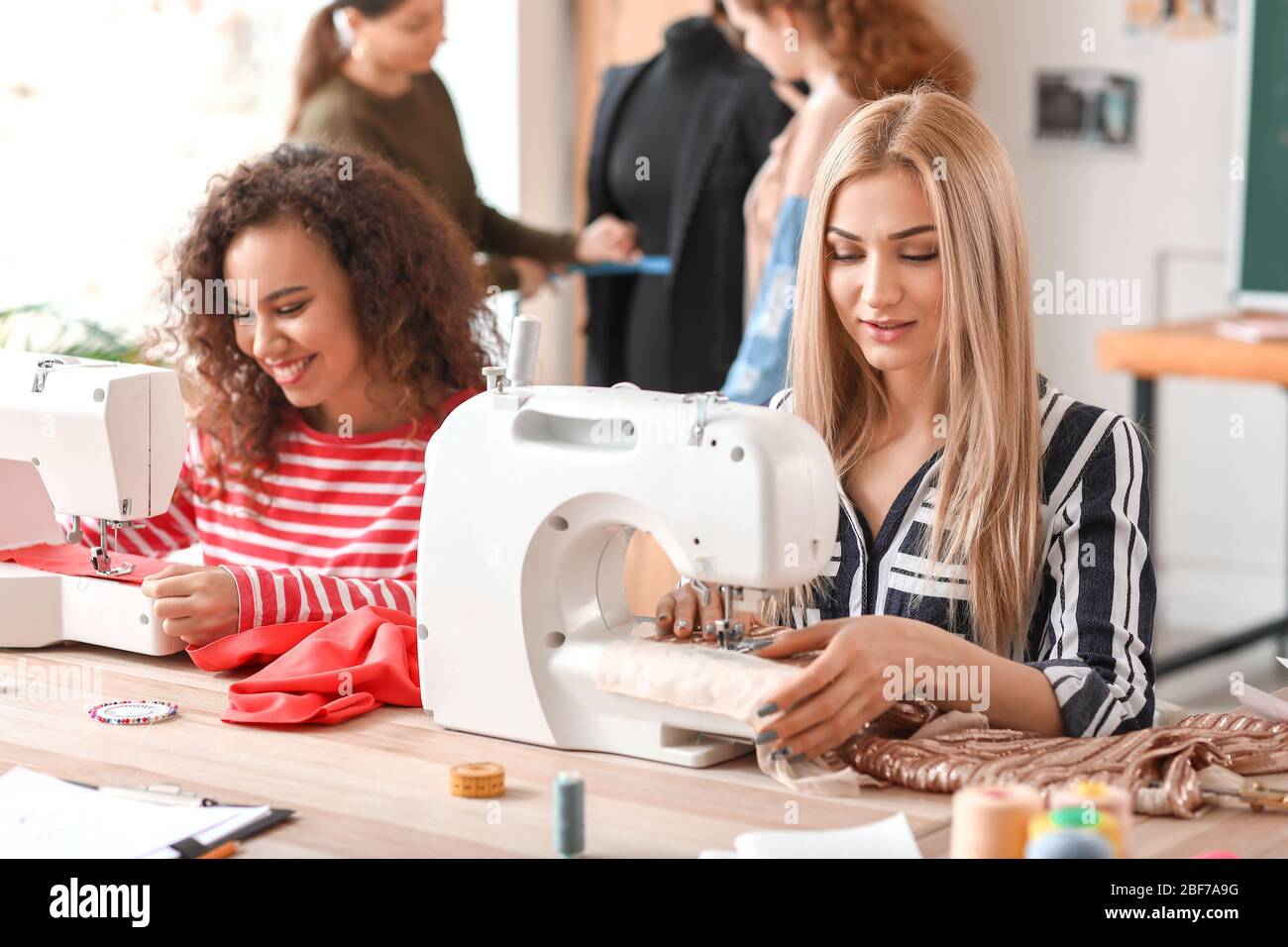 Young women during tailor's class in atelier Stock Photo - Alamy