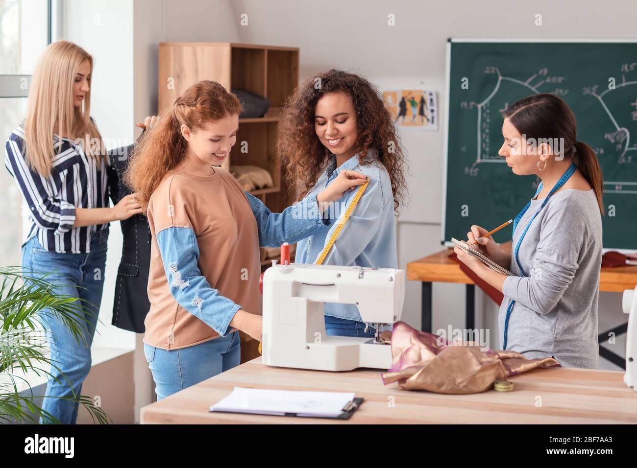 Young women during tailor's class in atelier Stock Photo - Alamy