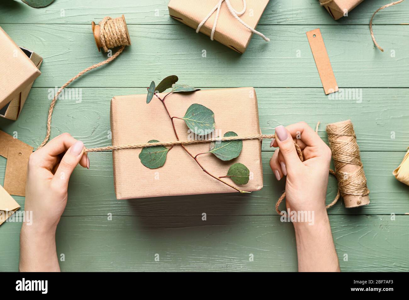 Woman packing surprise gift hi-res stock photography and images - Alamy