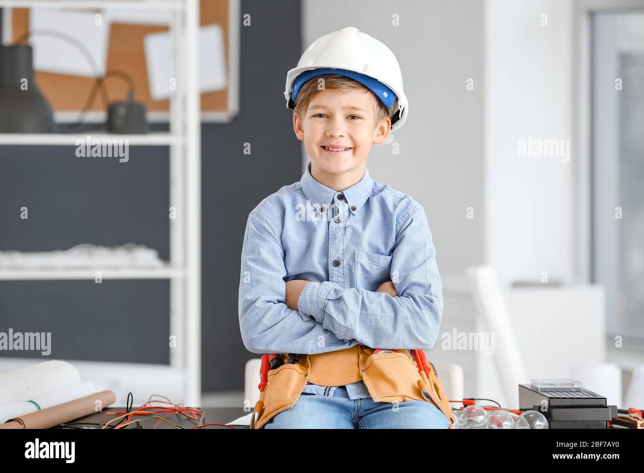 Cute little electrician in room Stock Photo - Alamy