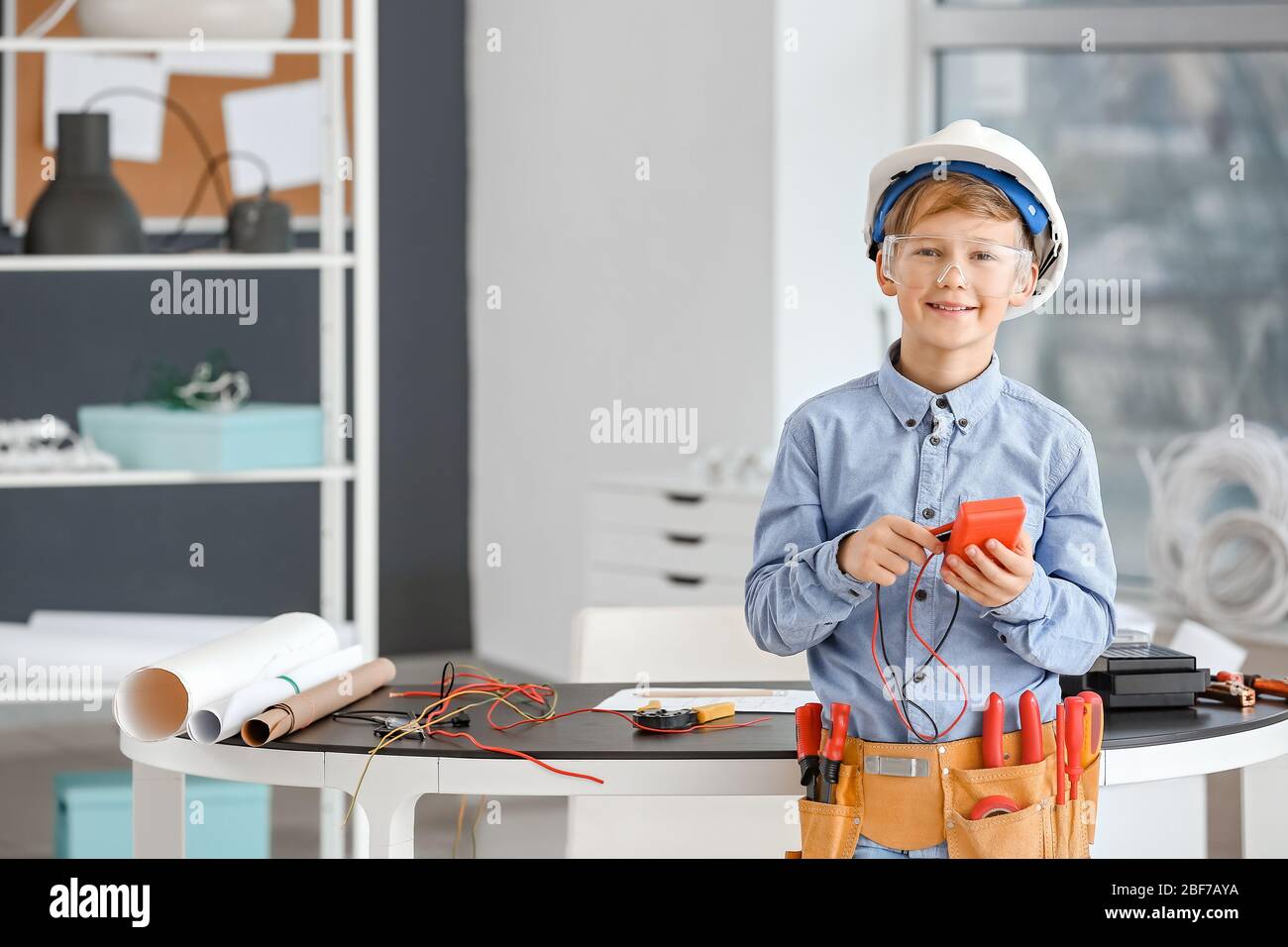 Cute little electrician in room Stock Photo - Alamy