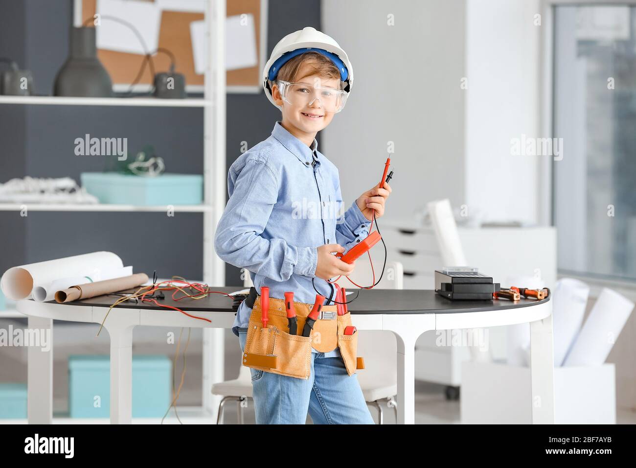 Cute little electrician in room Stock Photo - Alamy