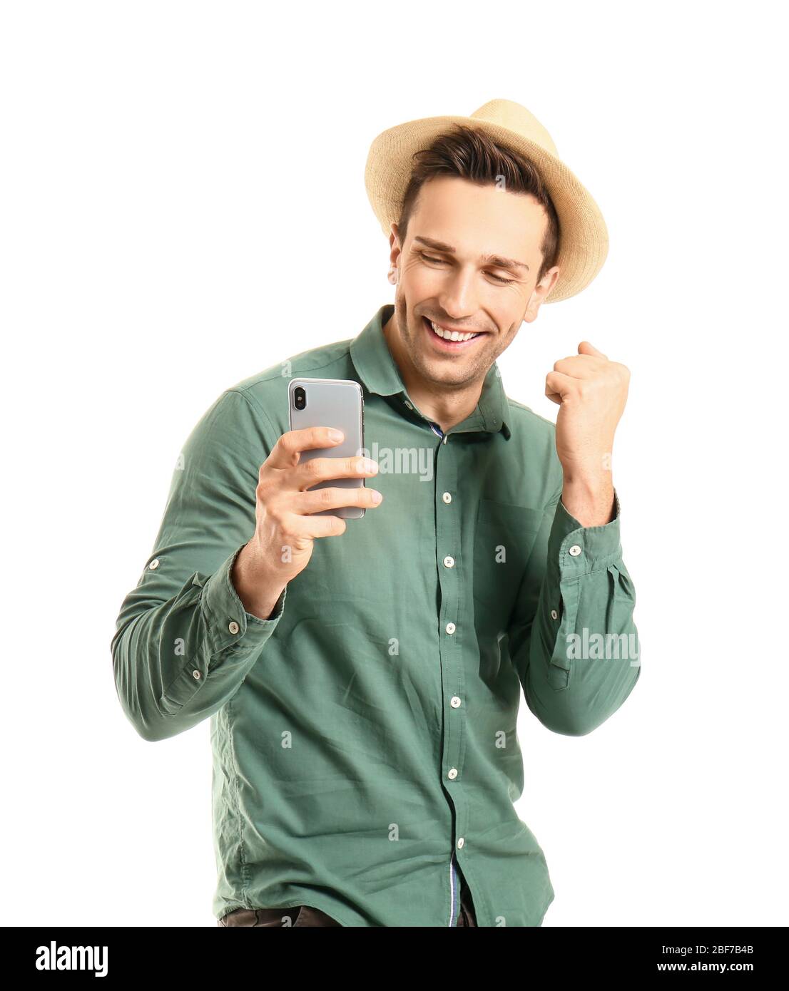 Cool young man with mobile phone dancing against white background Stock ...