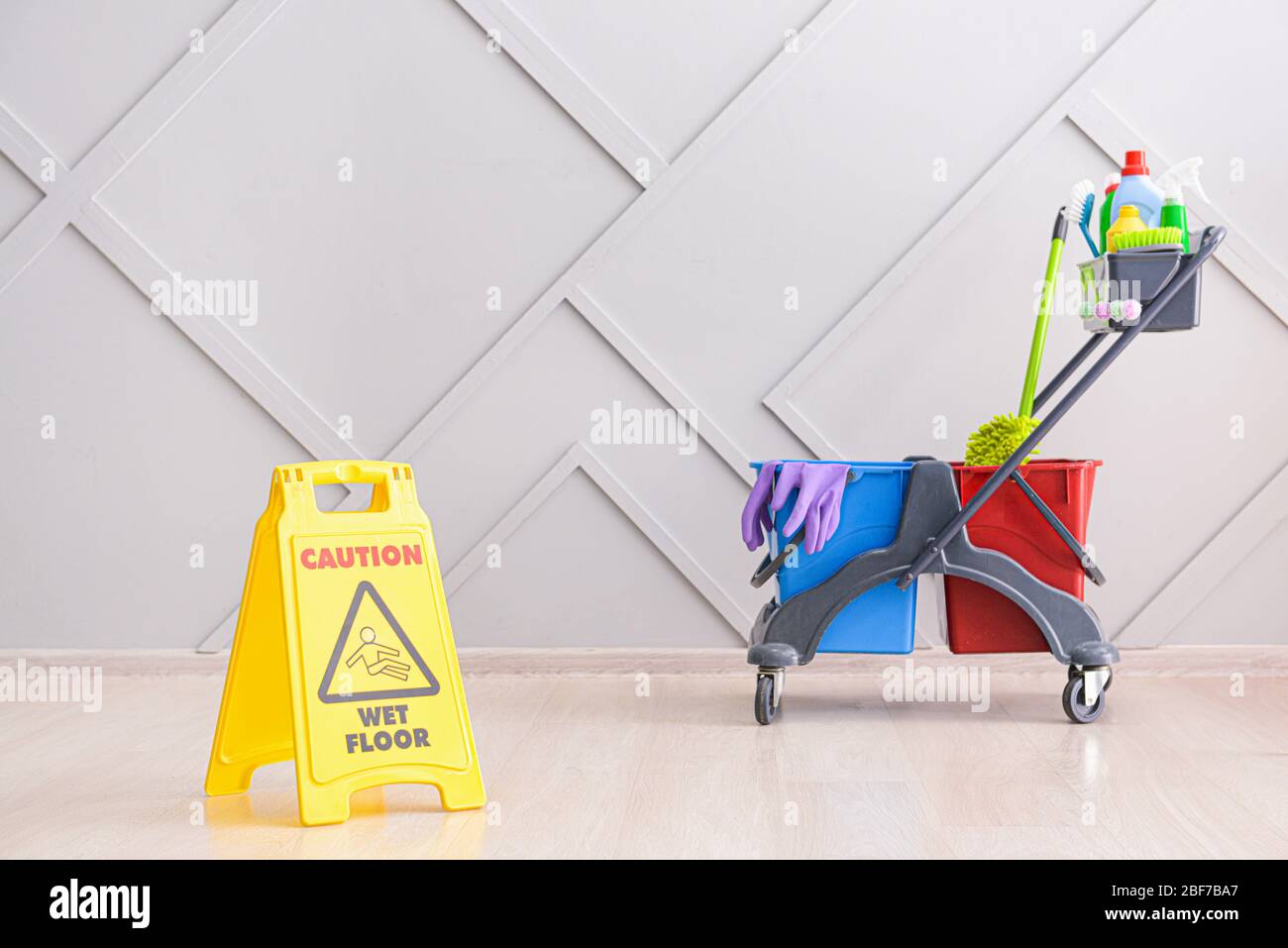 Caution sign with cleaning supplies indoors Stock Photo - Alamy