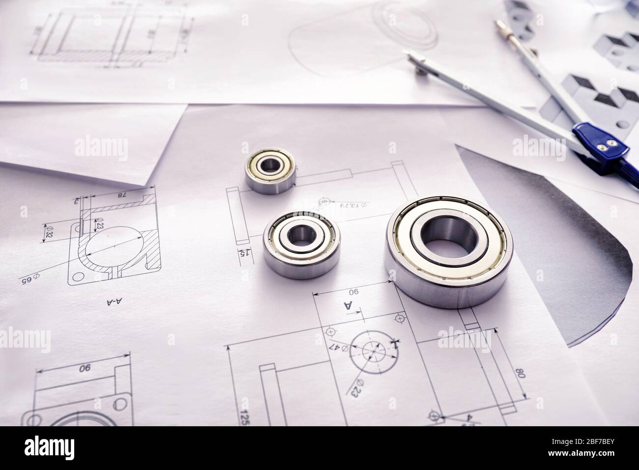 Bearings and drawings on table of engineer Stock Photo - Alamy