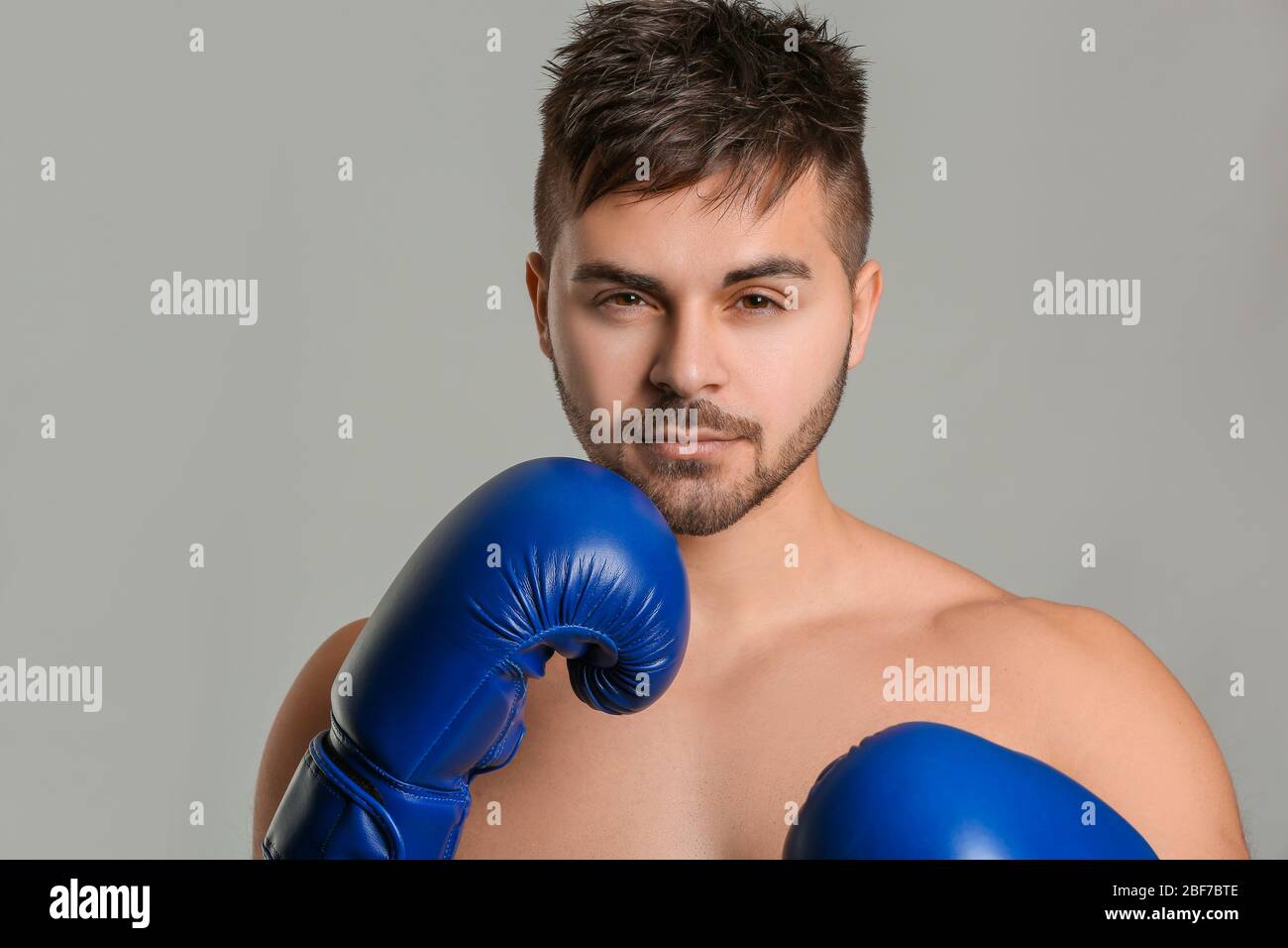 Sporty male boxer on grey background Stock Photo - Alamy