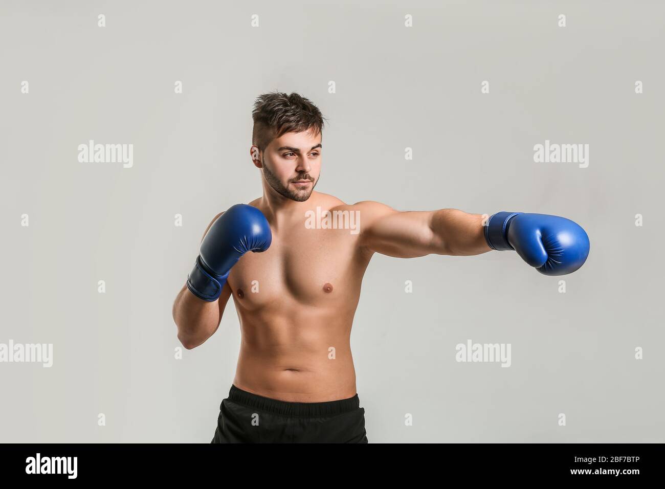 Sporty male boxer on grey background Stock Photo - Alamy