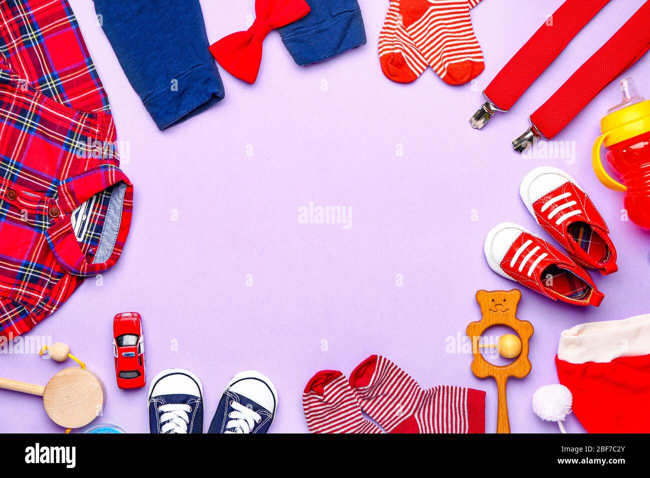 Frame made of baby clothes and accessories on color background Stock ...