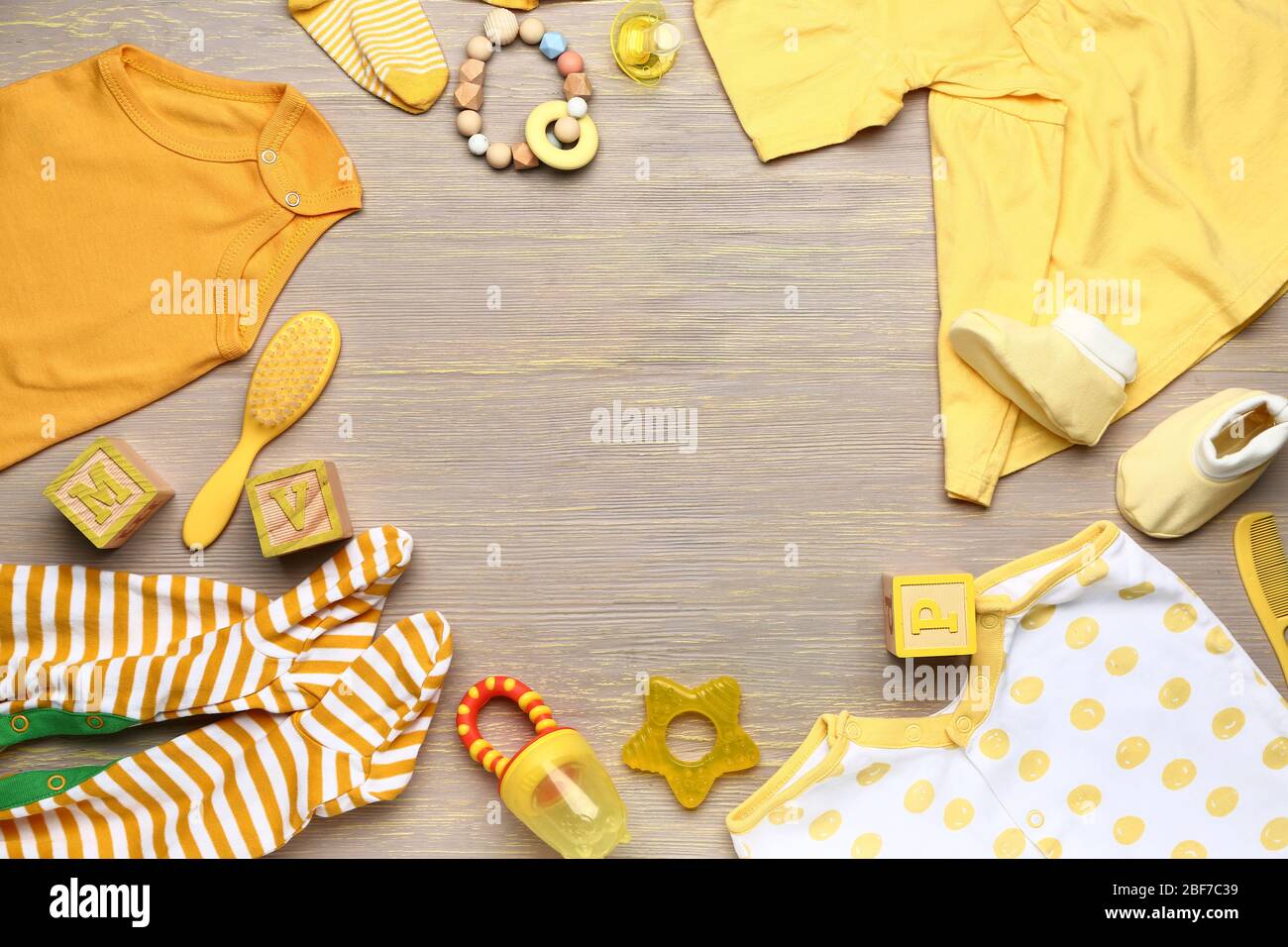 Frame made of baby clothes and accessories on wooden background Stock ...