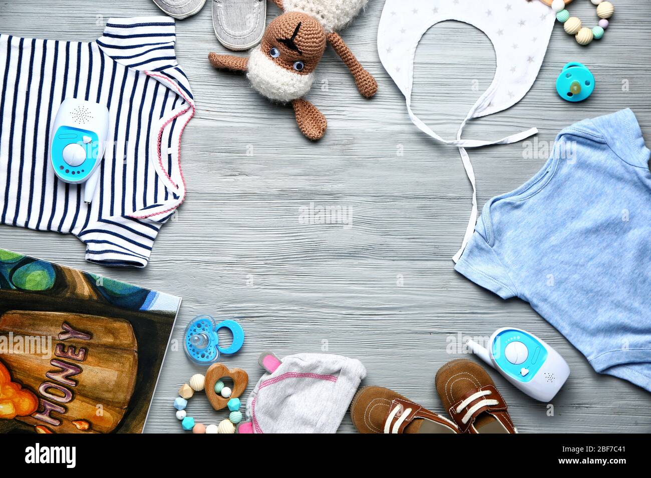 Frame made of baby clothes and accessories on wooden background Stock ...