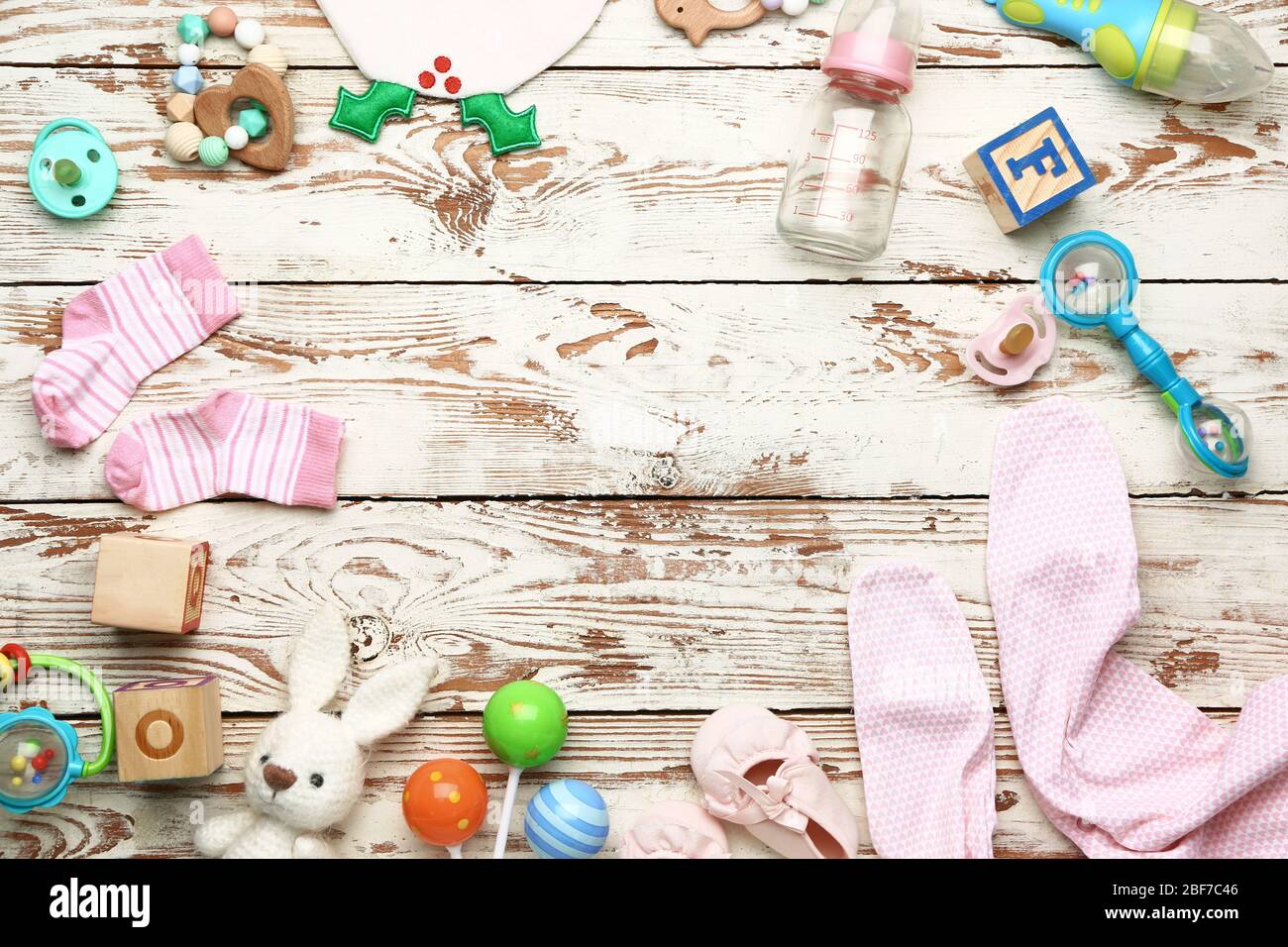 Frame made of baby clothes and accessories on wooden background Stock ...