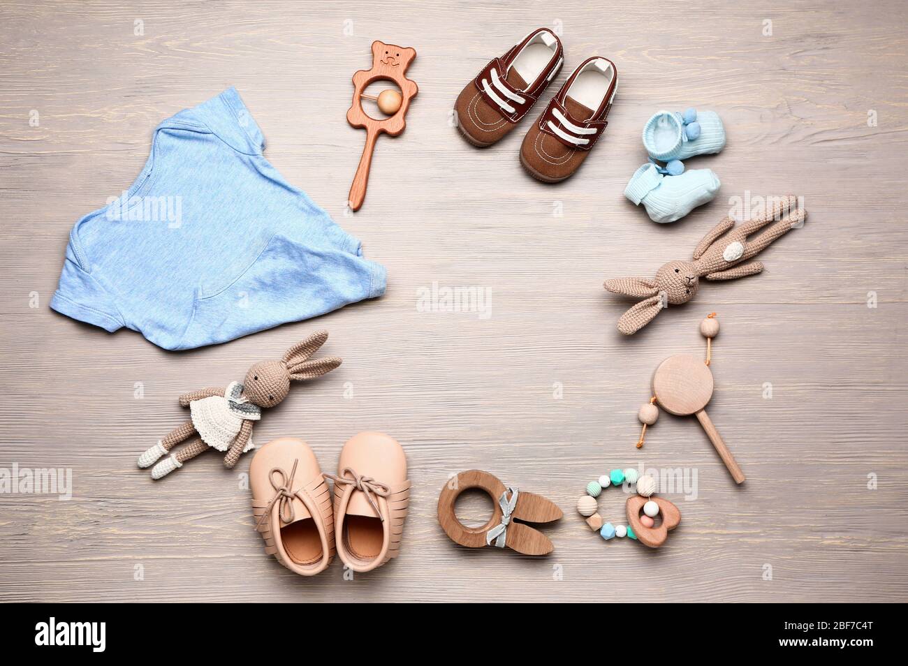 Frame made of baby clothes and accessories on wooden background Stock ...