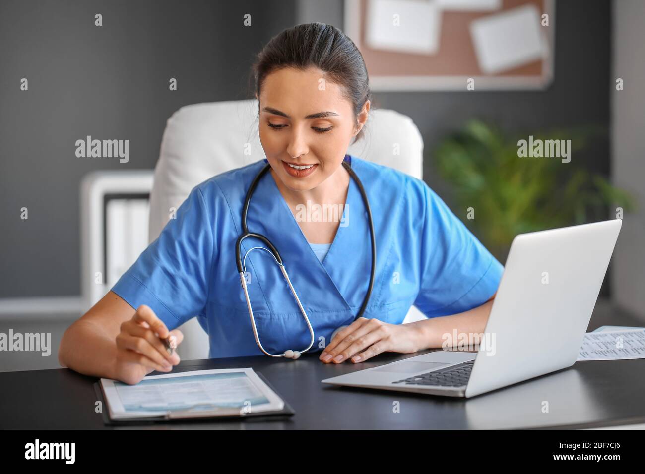 Young female doctor working in clinic Stock Photo - Alamy