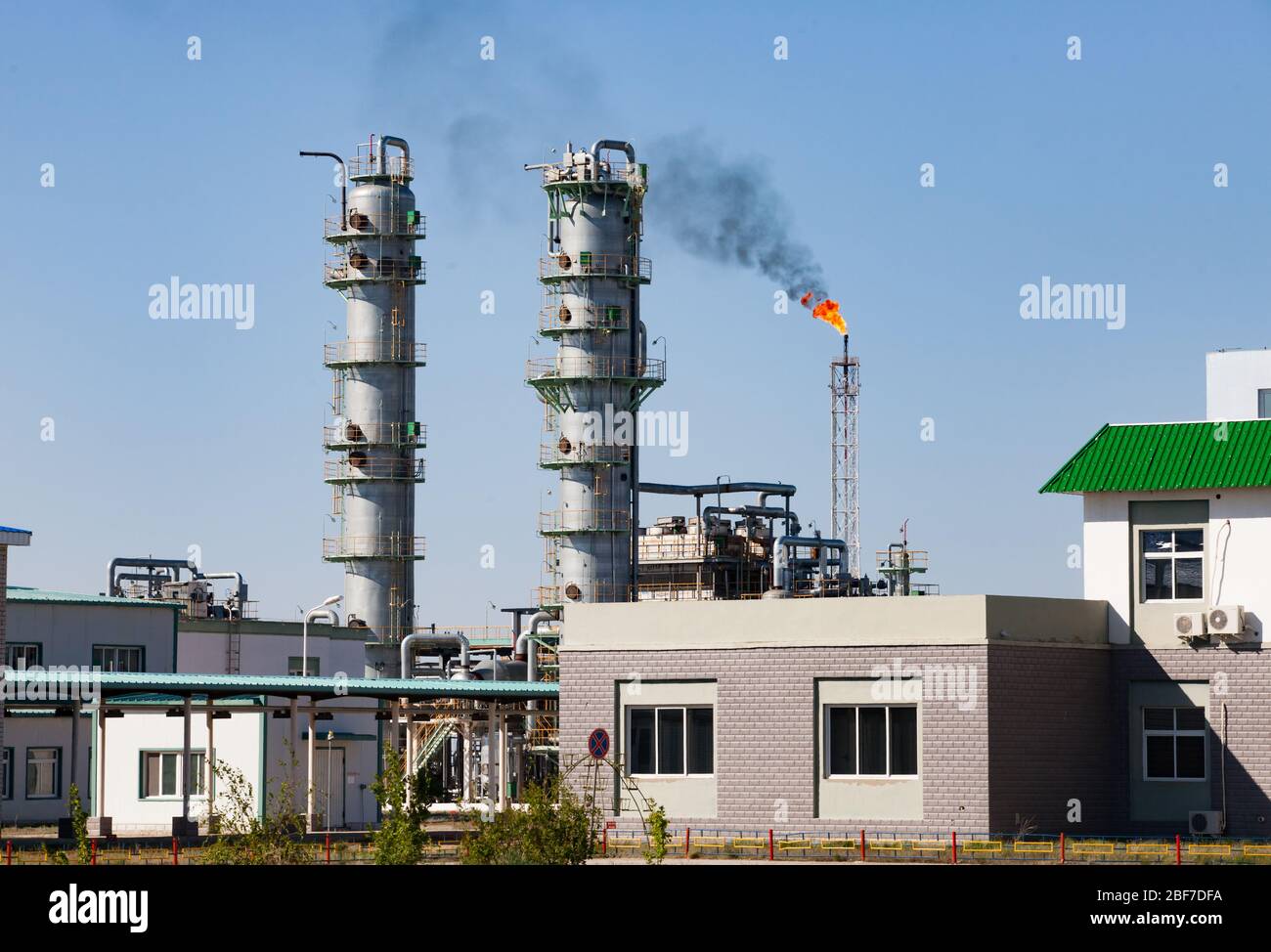 Distillation towers, burning gas torch, pipelines and industrial ...