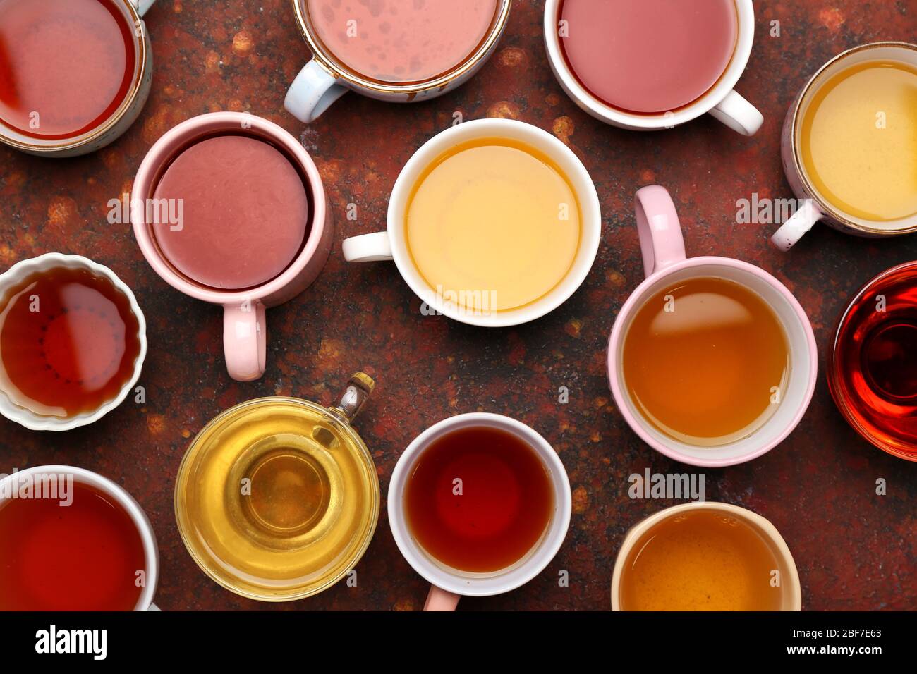 Cups with different types of hot tea on color background Stock Photo ...