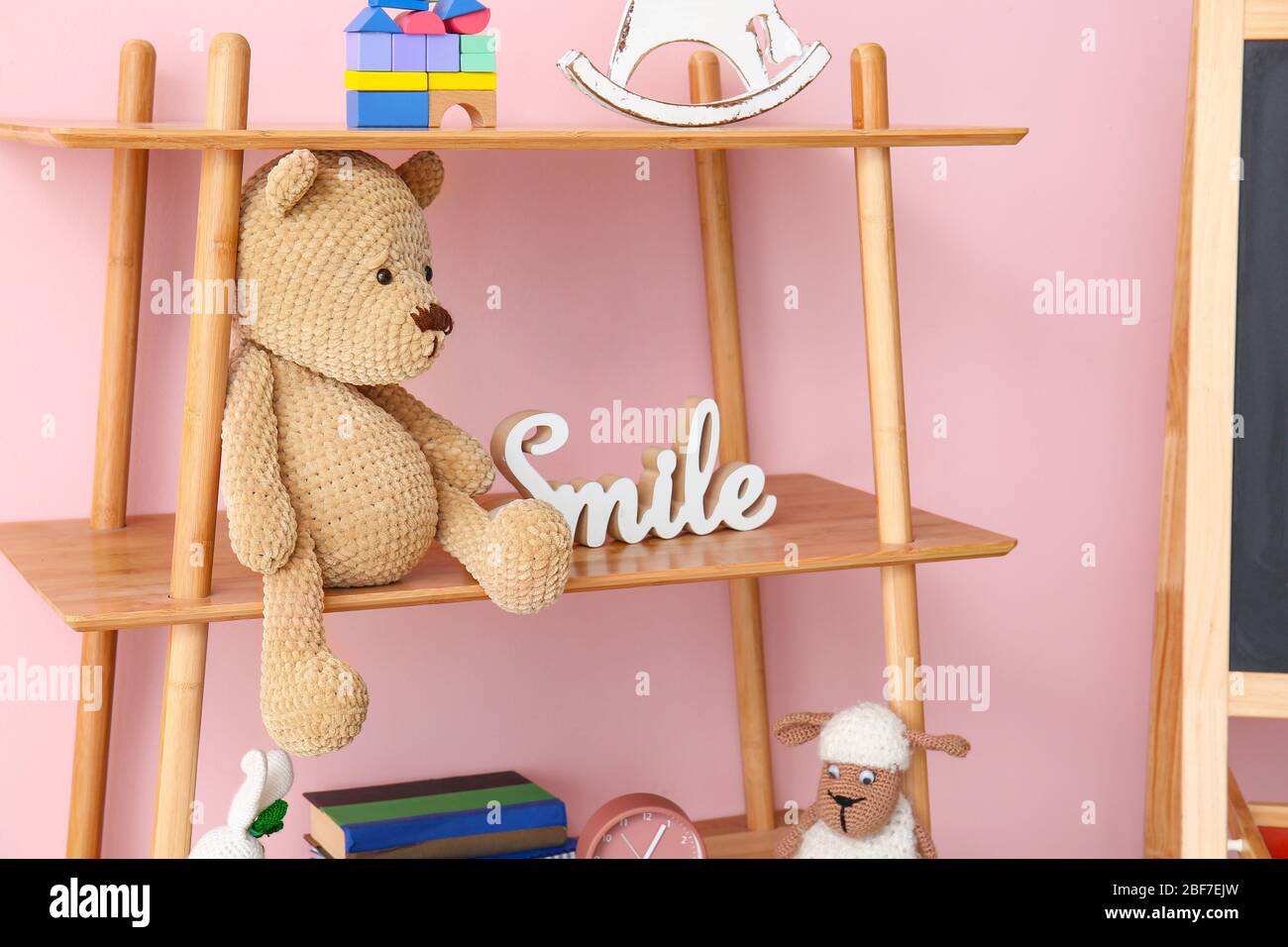 Cuddly toy on shelf in children's room Stock Photo - Alamy