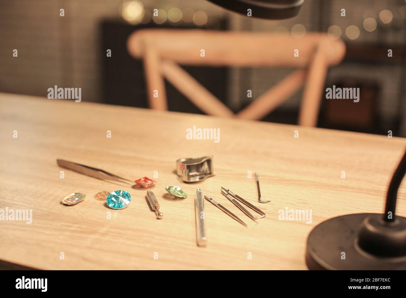 Gemstones and tools on table in jeweller's workshop Stock Photo - Alamy