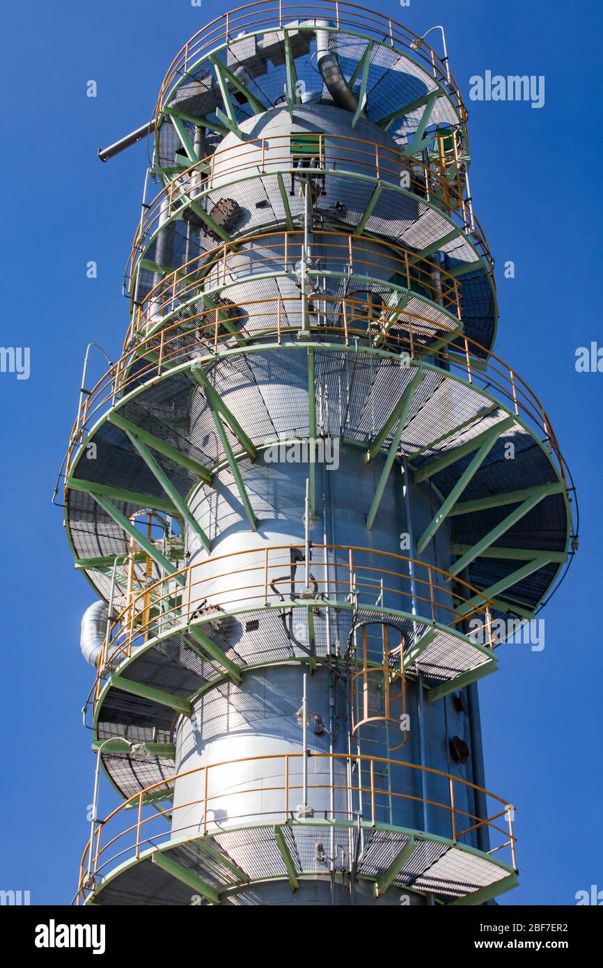 Closeup of oil distillation tower (refining column) on blue sky. on ...