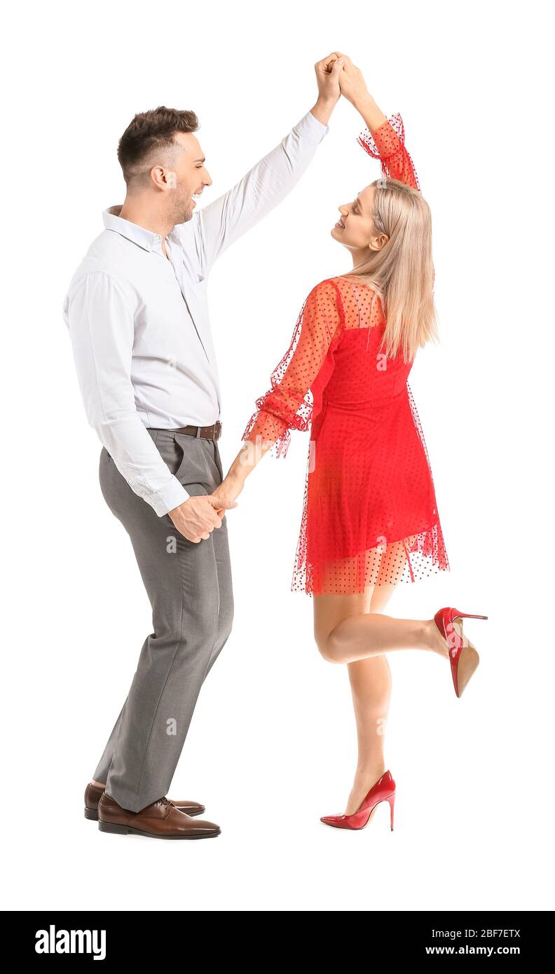Happy dancing young couple on white background Stock Photo - Alamy