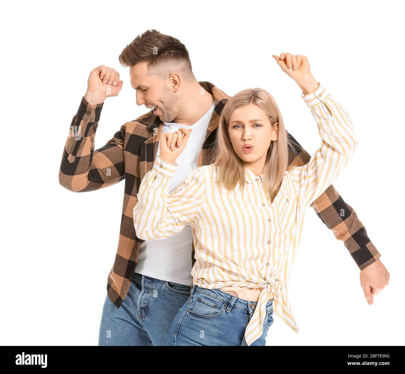 Happy dancing young couple on white background Stock Photo - Alamy
