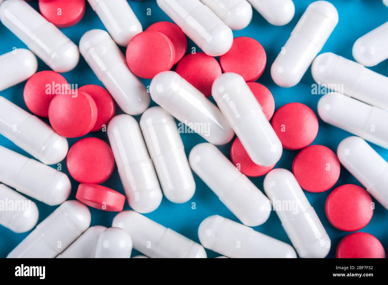 Blue background with red and white tablets. Background for a medical ...