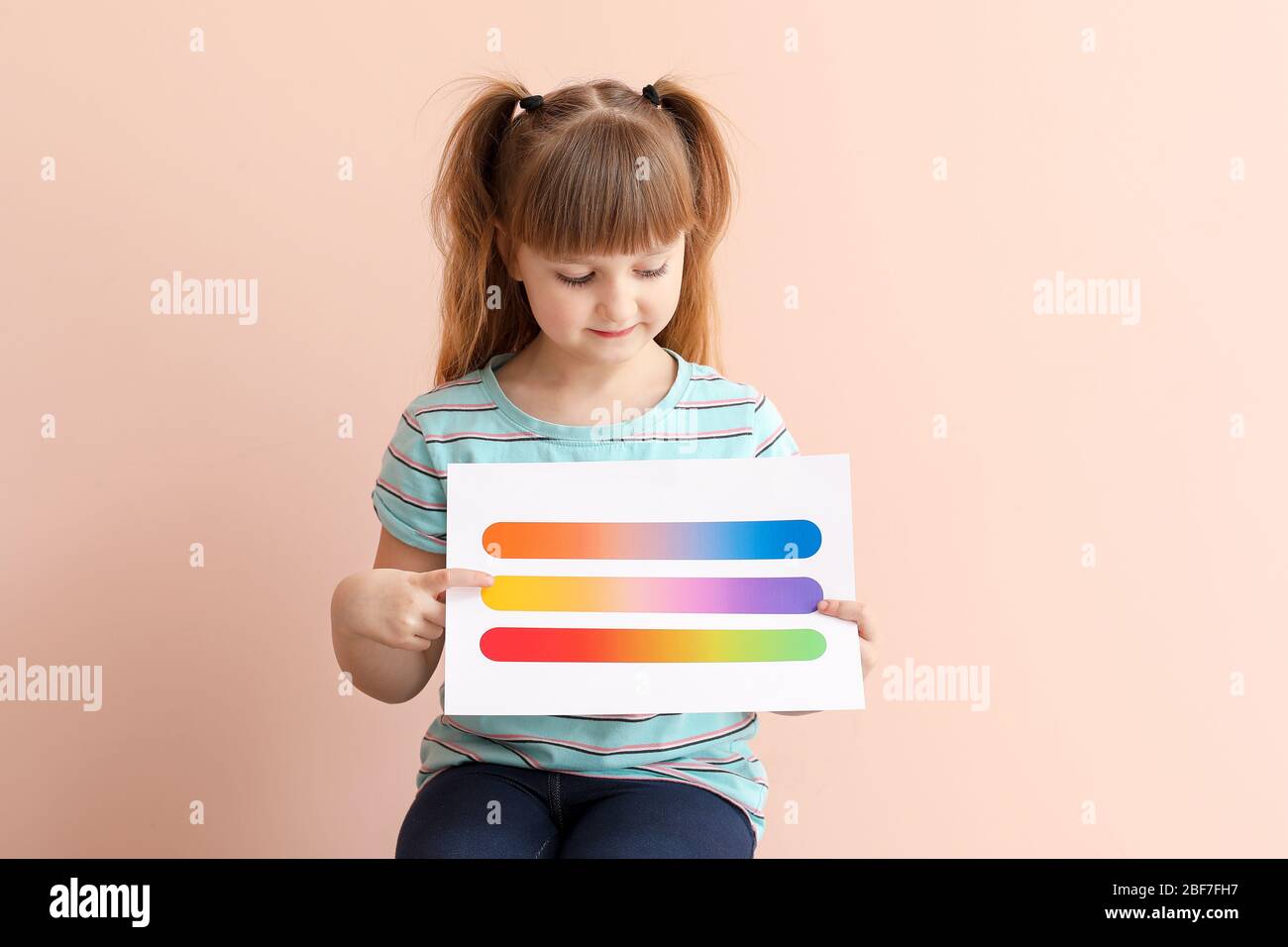 Little girl with color palettes on pink background Stock Photo - Alamy