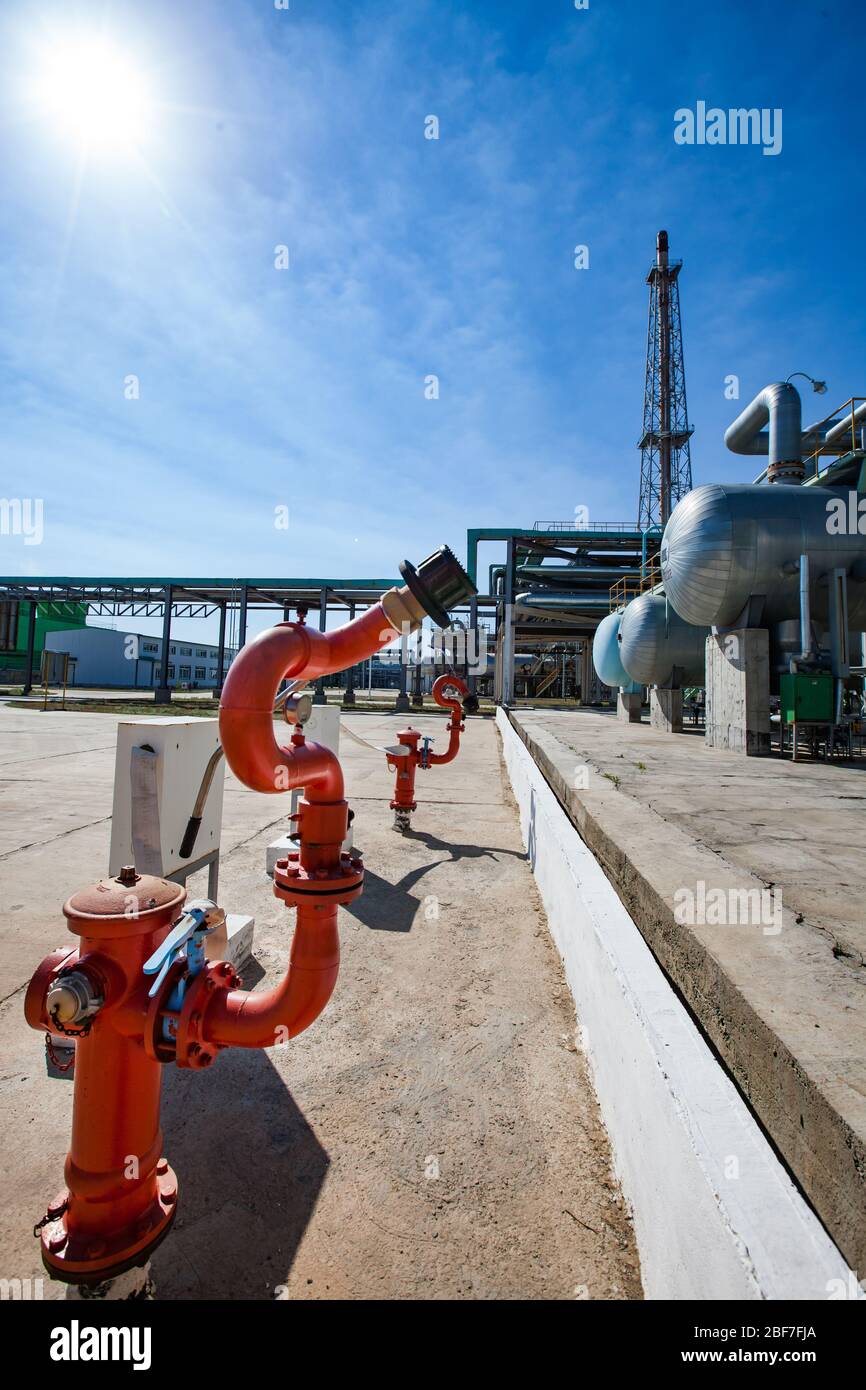 Petrochemical plant. (Oil refinery plant). Red fire extinguisher and ...