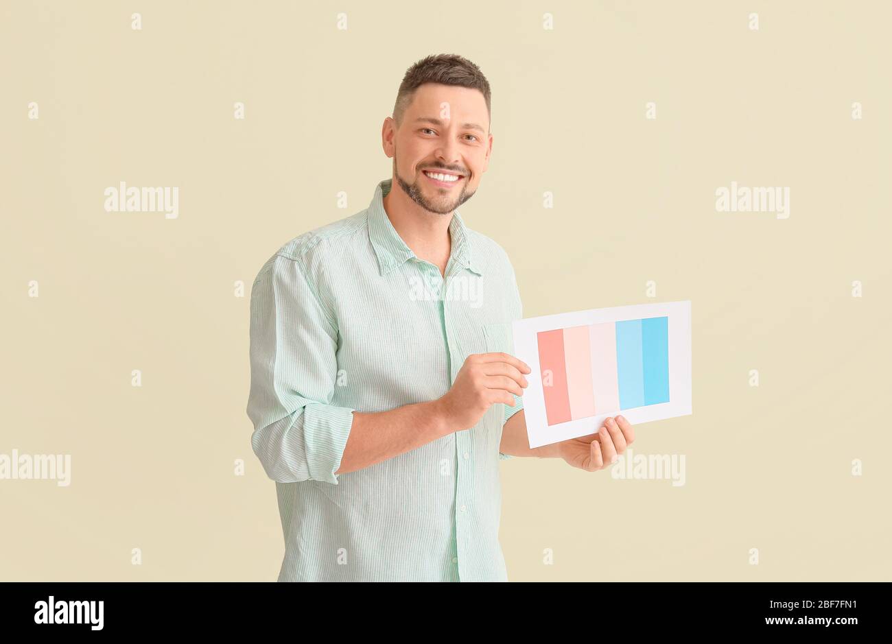 Man with color palettes on light background Stock Photo - Alamy