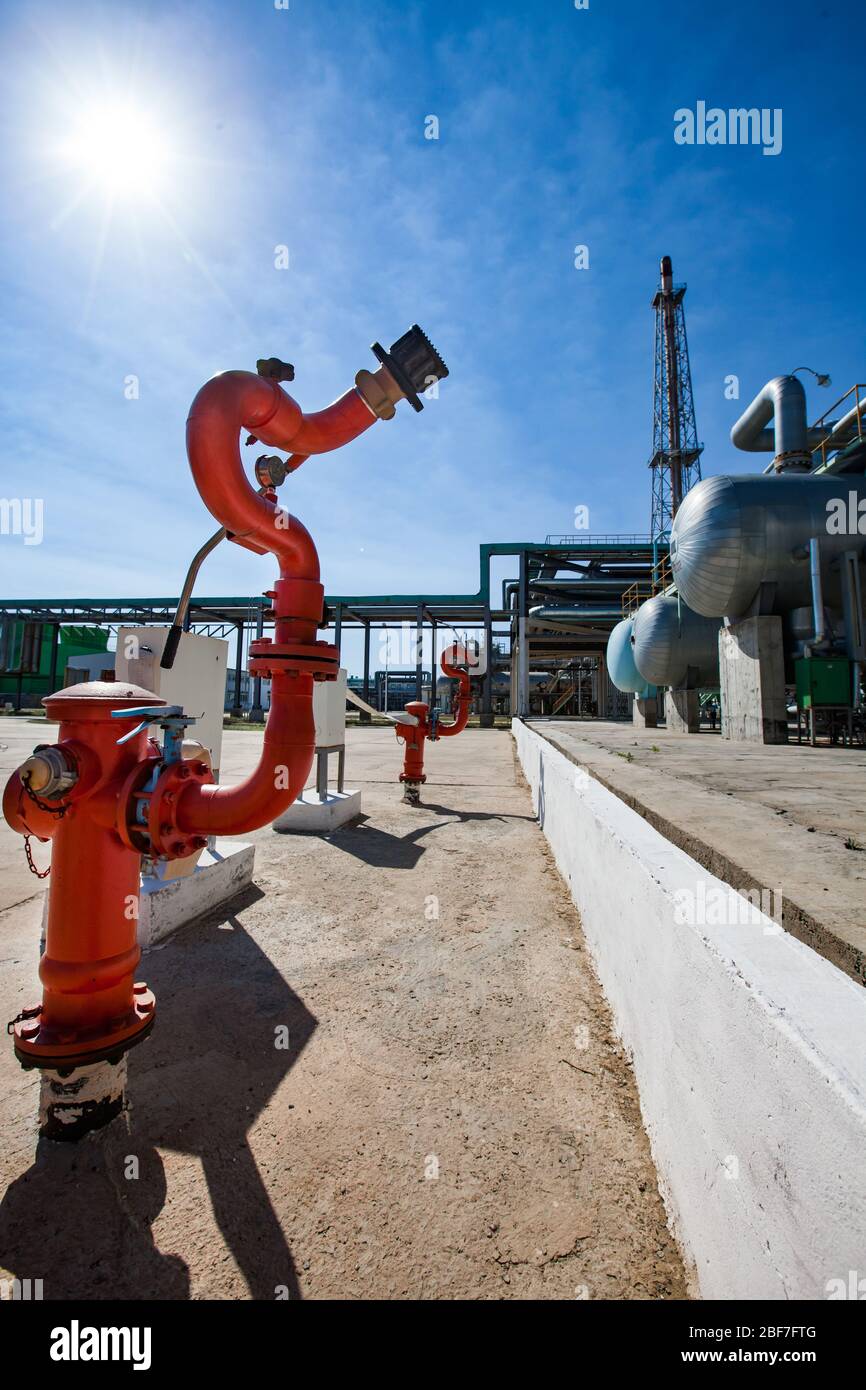 Petrochemical plant. (Oil refinery plant). Red fire extinguisher and ...