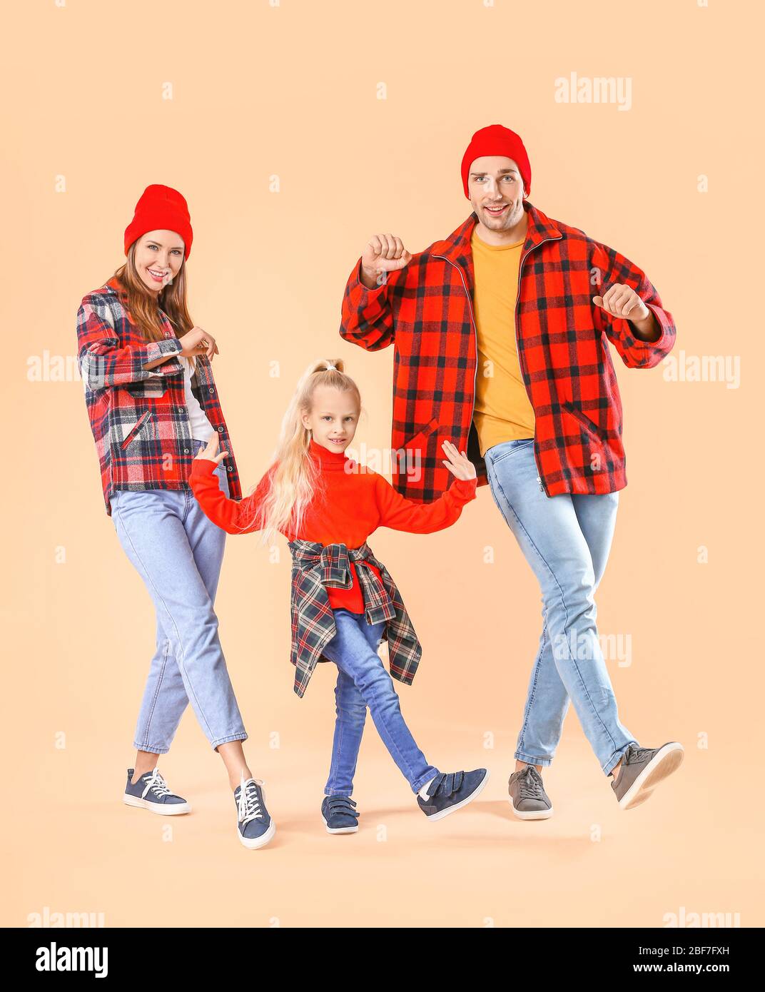 Happy family dancing against color background Stock Photo - Alamy