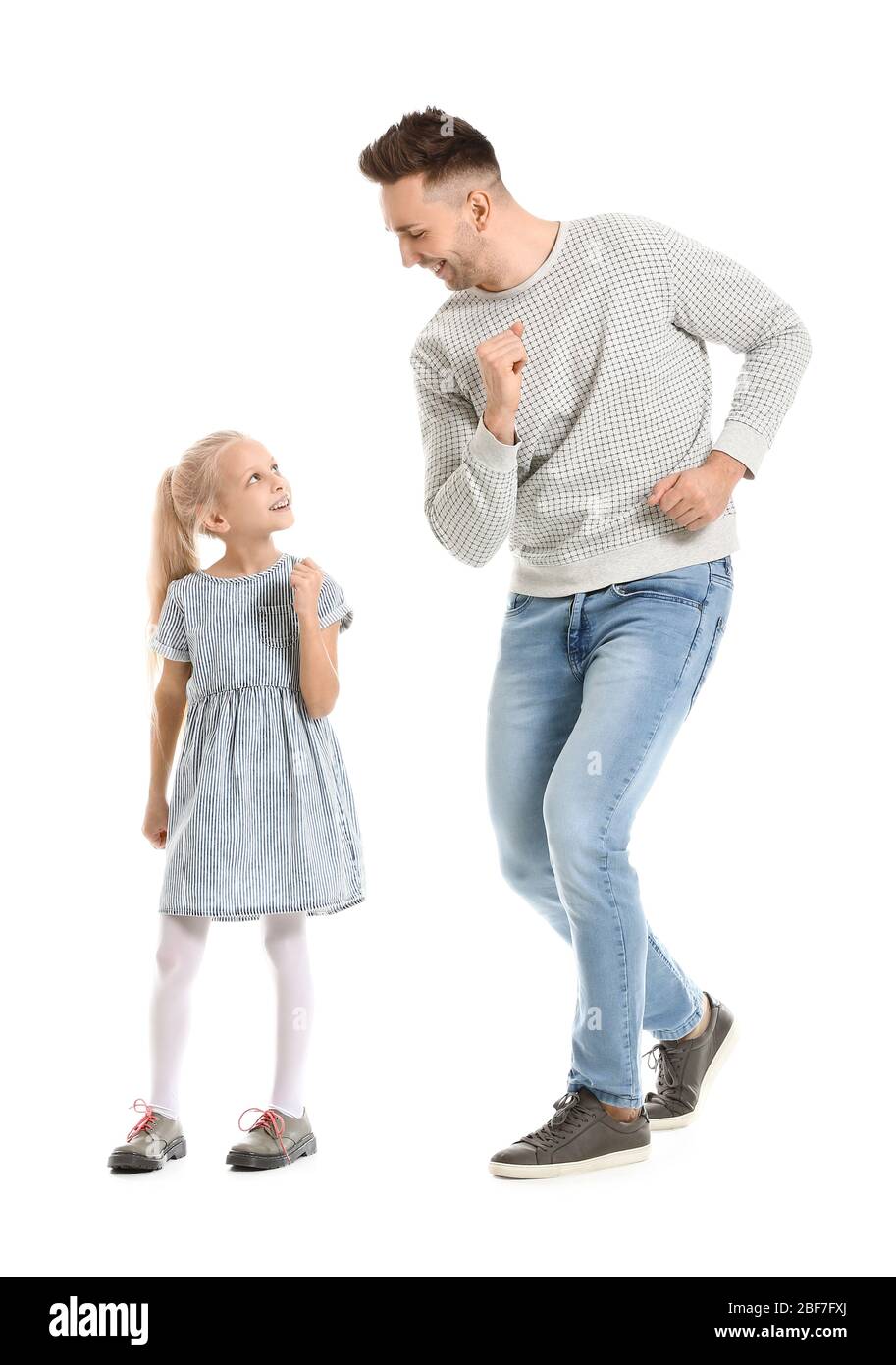 Man and his little daughter dancing against white background Stock ...