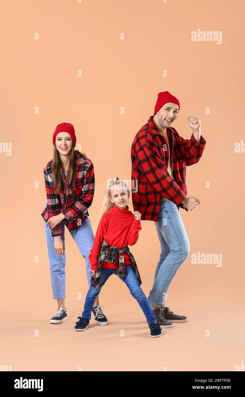 Happy family dancing against color background Stock Photo - Alamy