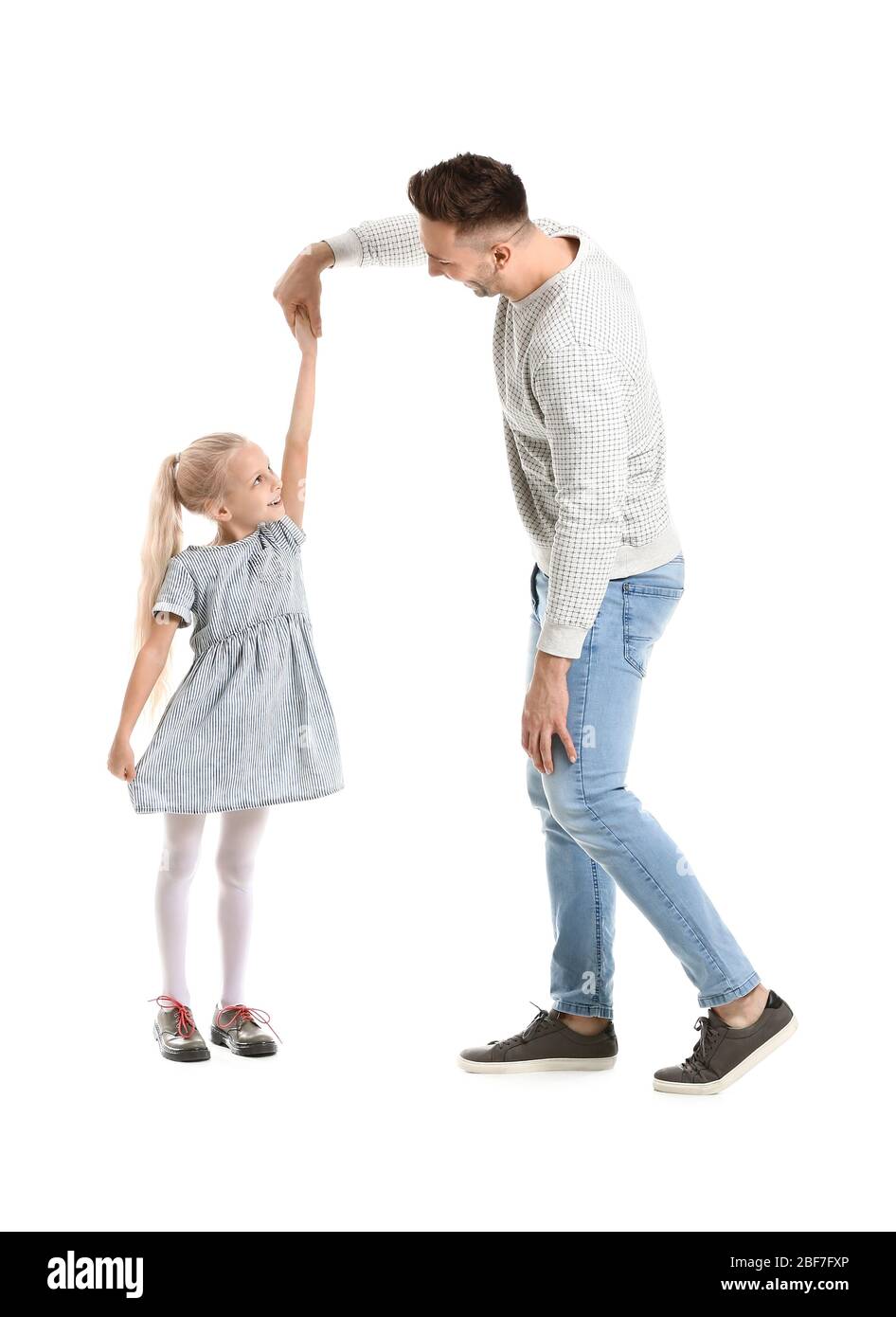 Man and his little daughter dancing against white background Stock ...