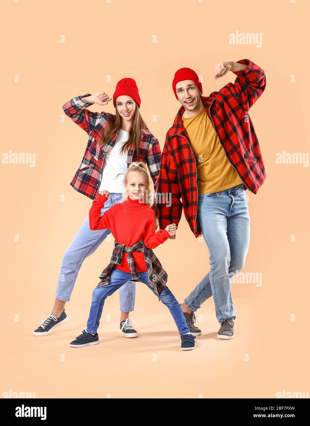 Happy family dancing against color background Stock Photo - Alamy