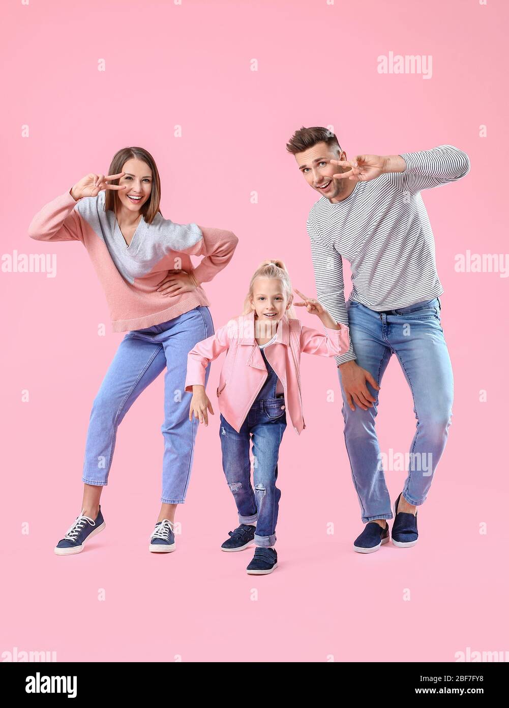 Happy family dancing against color background Stock Photo - Alamy