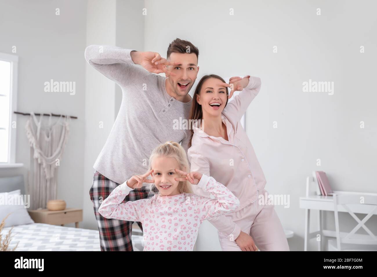 Happy family dancing in bedroom Stock Photo - Alamy