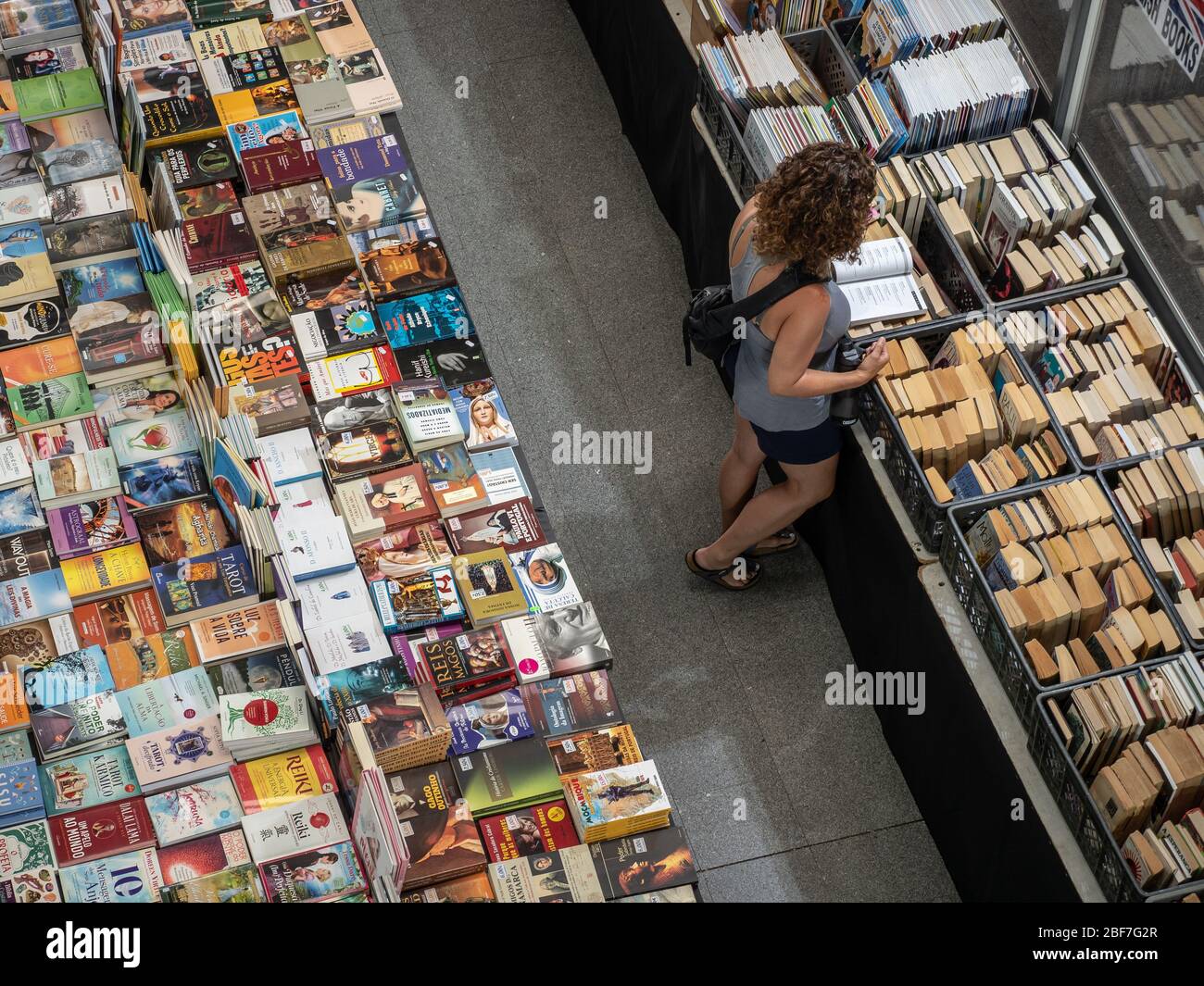 Indoor book market. Candid high angle view of a young woman browsing ...
