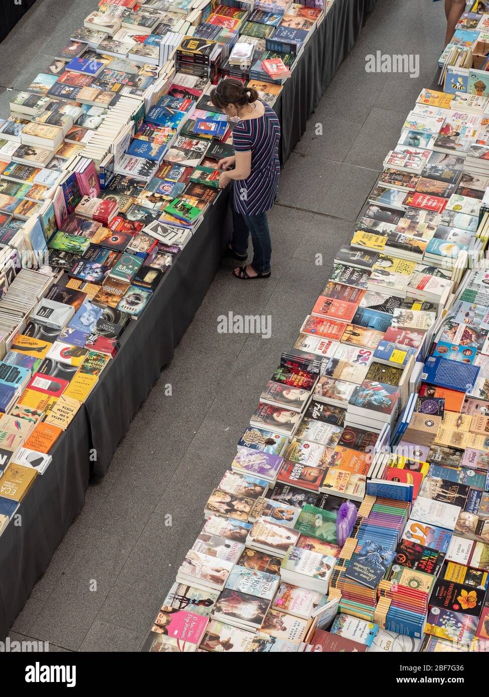 Indoor book market. Candid high angle view of an anonymous woman ...