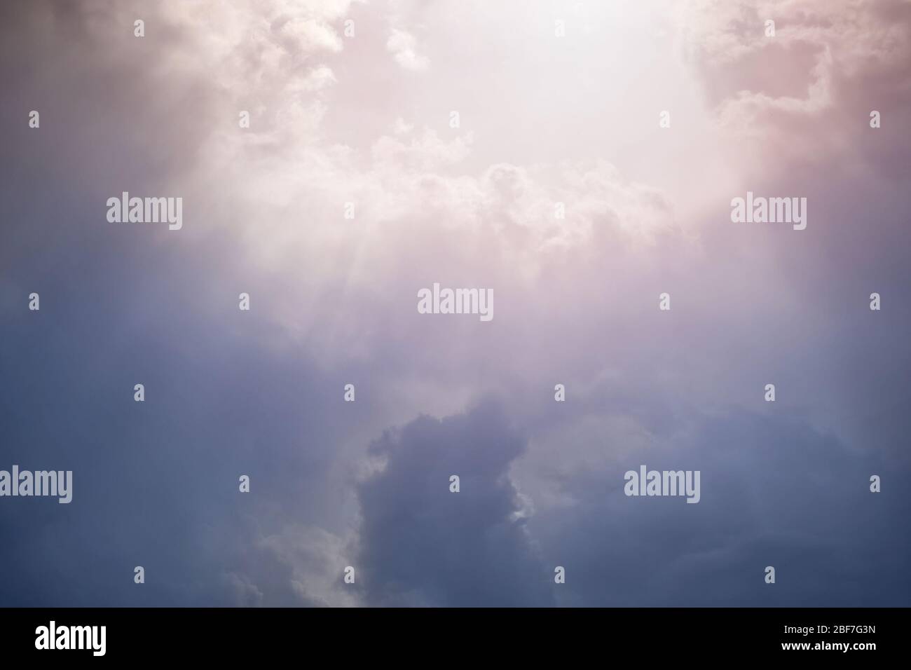 Sunlight breaks through the dense cloudy sky Stock Photo - Alamy